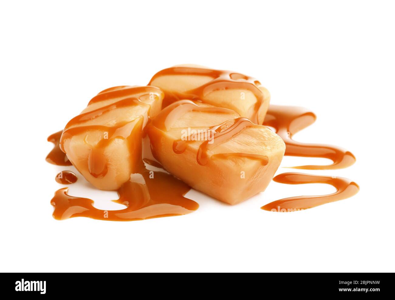 Delicious candies with caramel sauce on white background Stock Photo ...