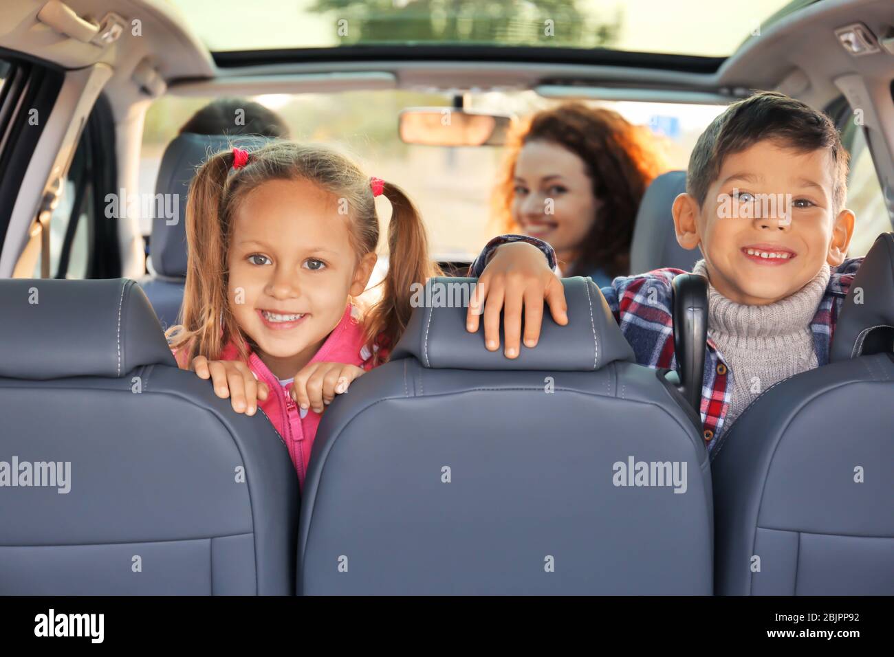 Cute children with parents in car Stock Photo - Alamy