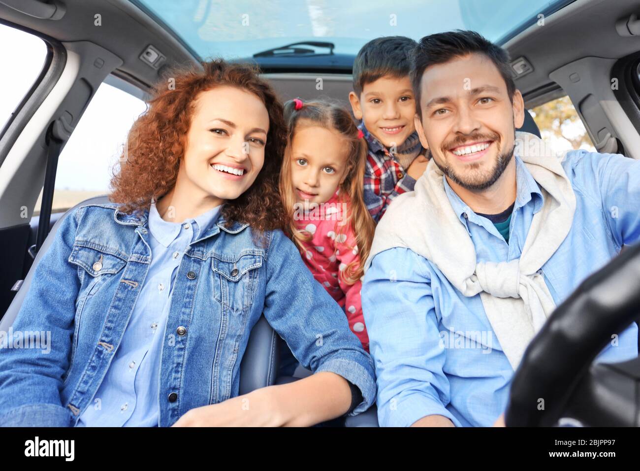 Car inside parents children hi-res stock photography and images - Alamy