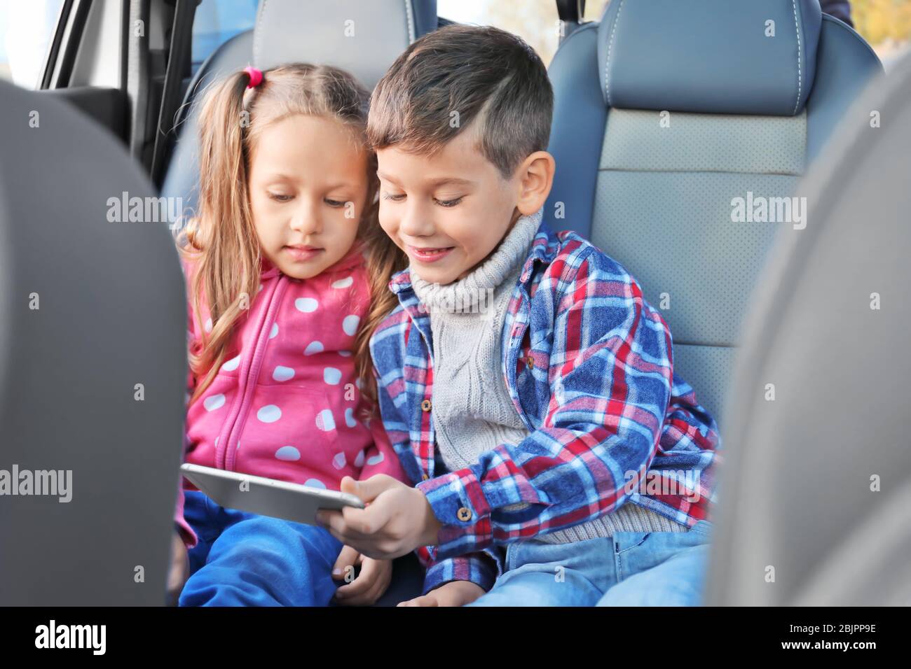 Cute children in car Stock Photo - Alamy