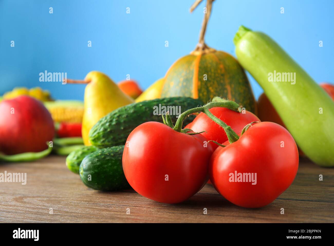 Composition of different fruits and vegetables on wooden table against ...