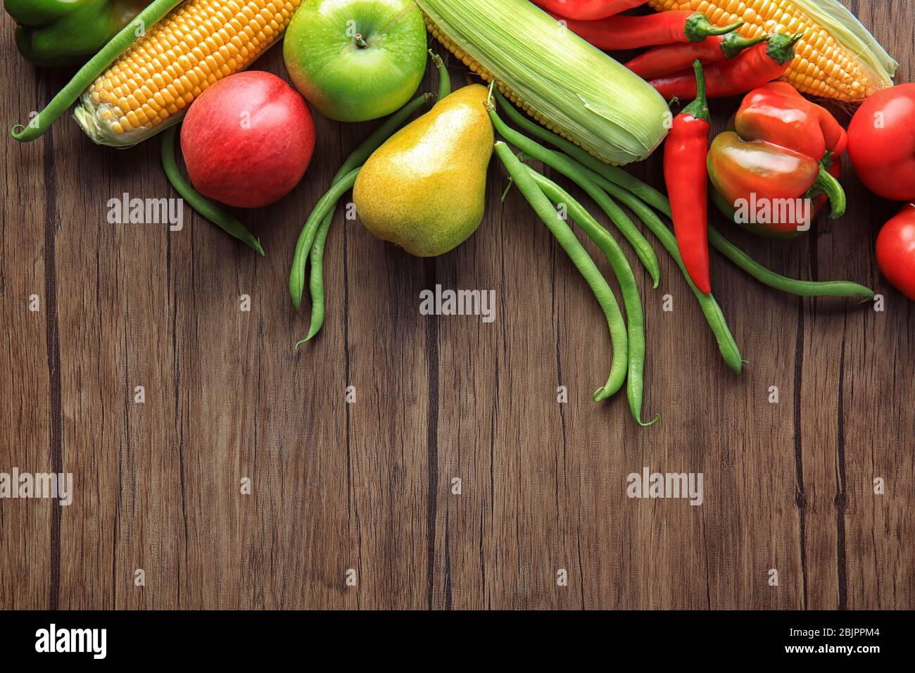 Composition of different fruits and vegetables on wooden background ...