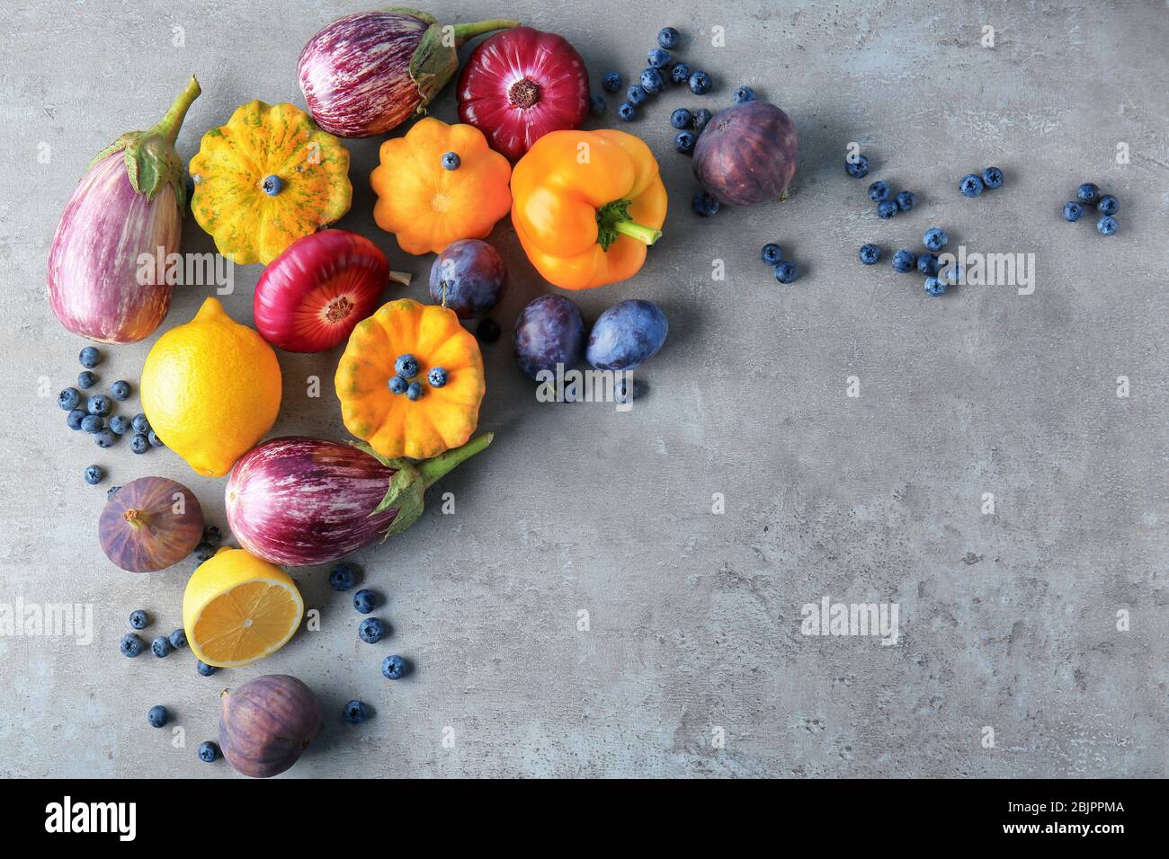 Composition of different fruits and vegetables on grey background Stock ...