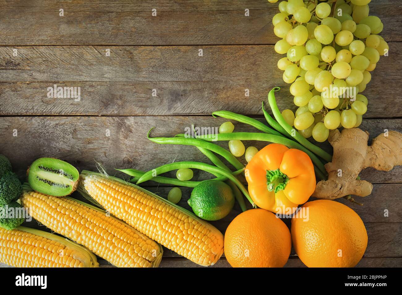 Composition of different fruits and vegetables on wooden background ...