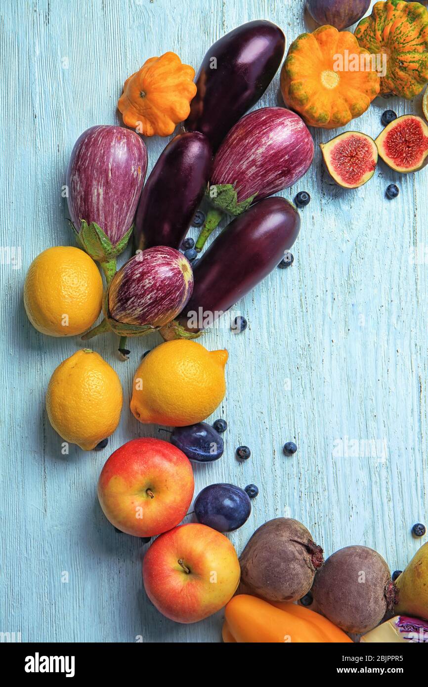 Composition of different fruits and vegetables on white wooden ...