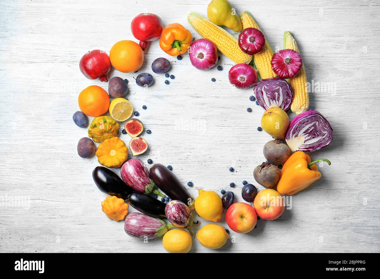 Composition of different fruits and vegetables on white wooden ...