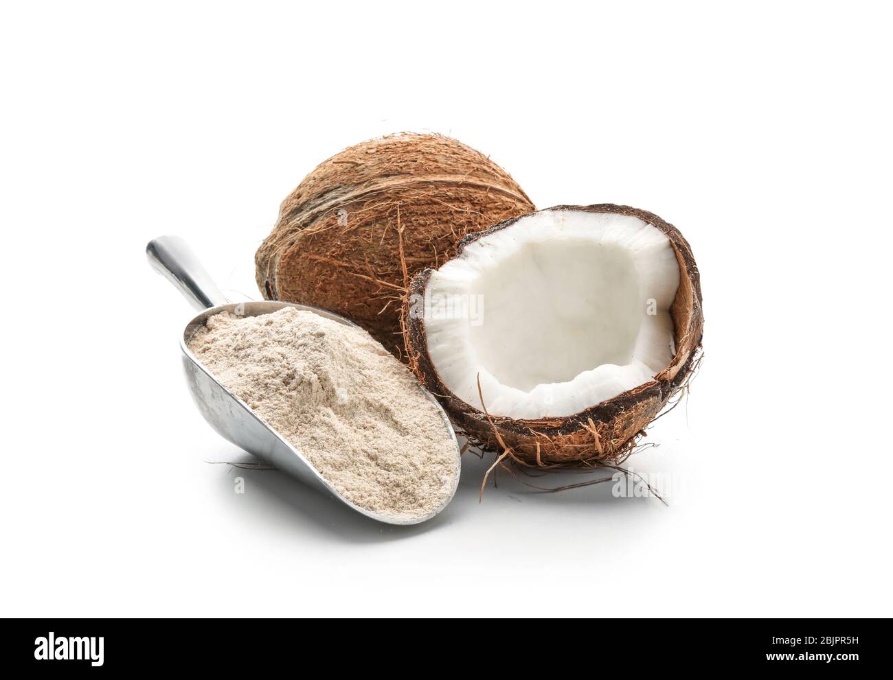 Scoop with coconut flour and nut on white background Stock Photo - Alamy