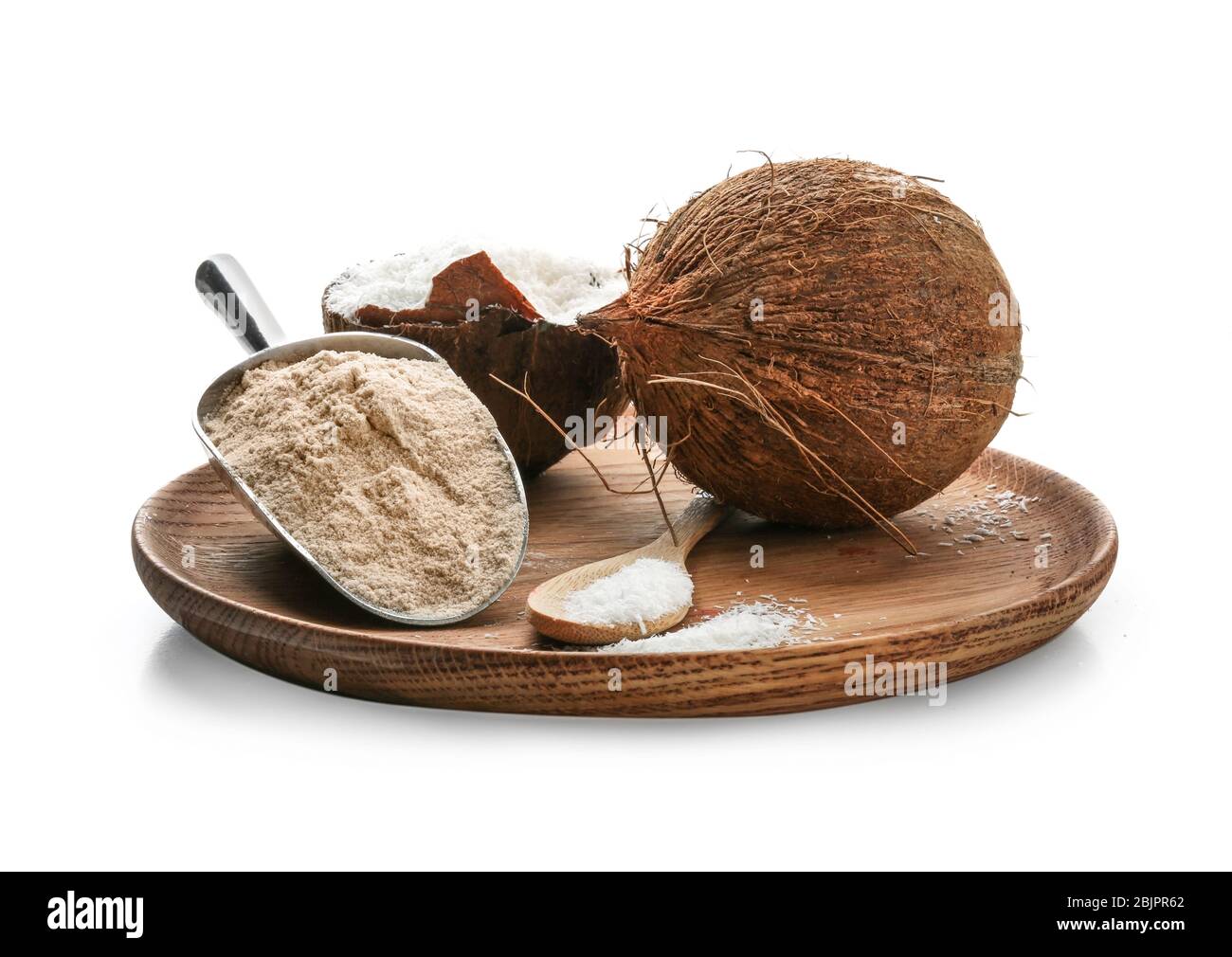 Scoop with coconut flour and nut on white background Stock Photo - Alamy