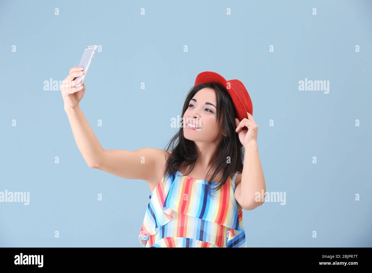 Beautiful woman taking selfie on color background Stock Photo - Alamy