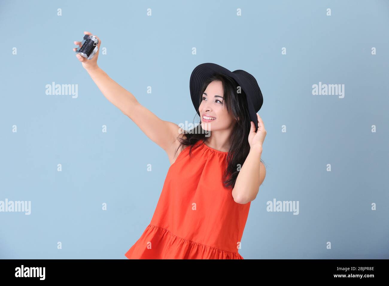 Beautiful woman taking selfie on color background Stock Photo - Alamy