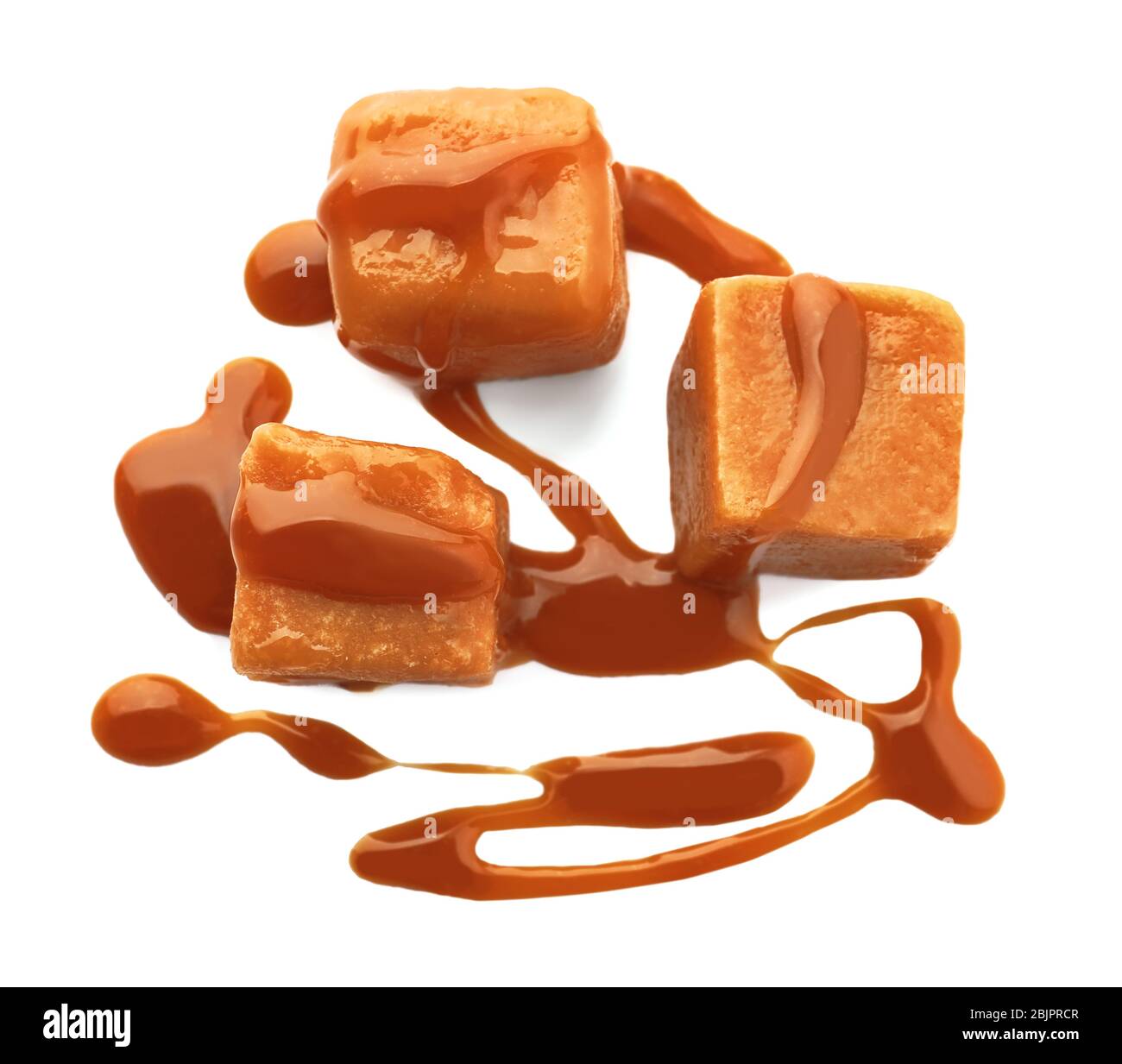 Delicious candies with caramel sauce on white background Stock Photo ...