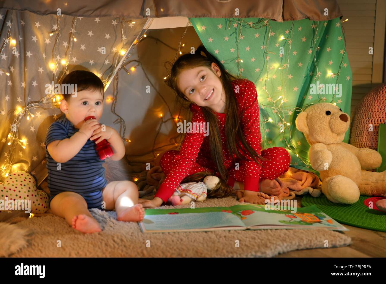 Cute children playing in hovel at home Stock Photo - Alamy