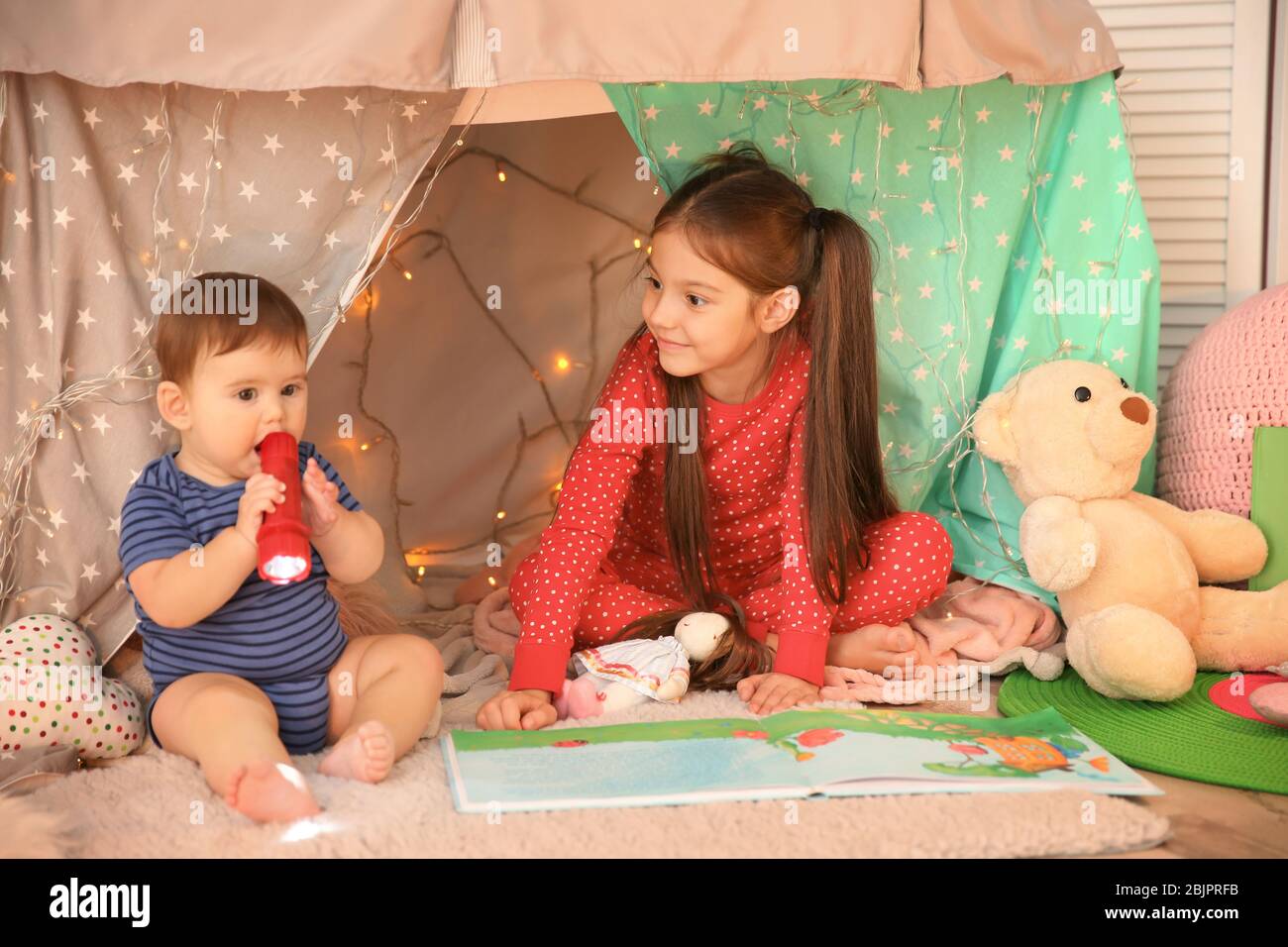 Cute children playing in hovel at home Stock Photo - Alamy