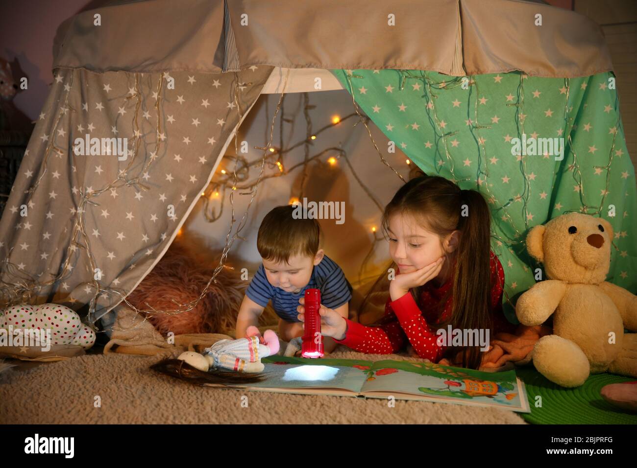 Cute children playing in hovel at home Stock Photo - Alamy