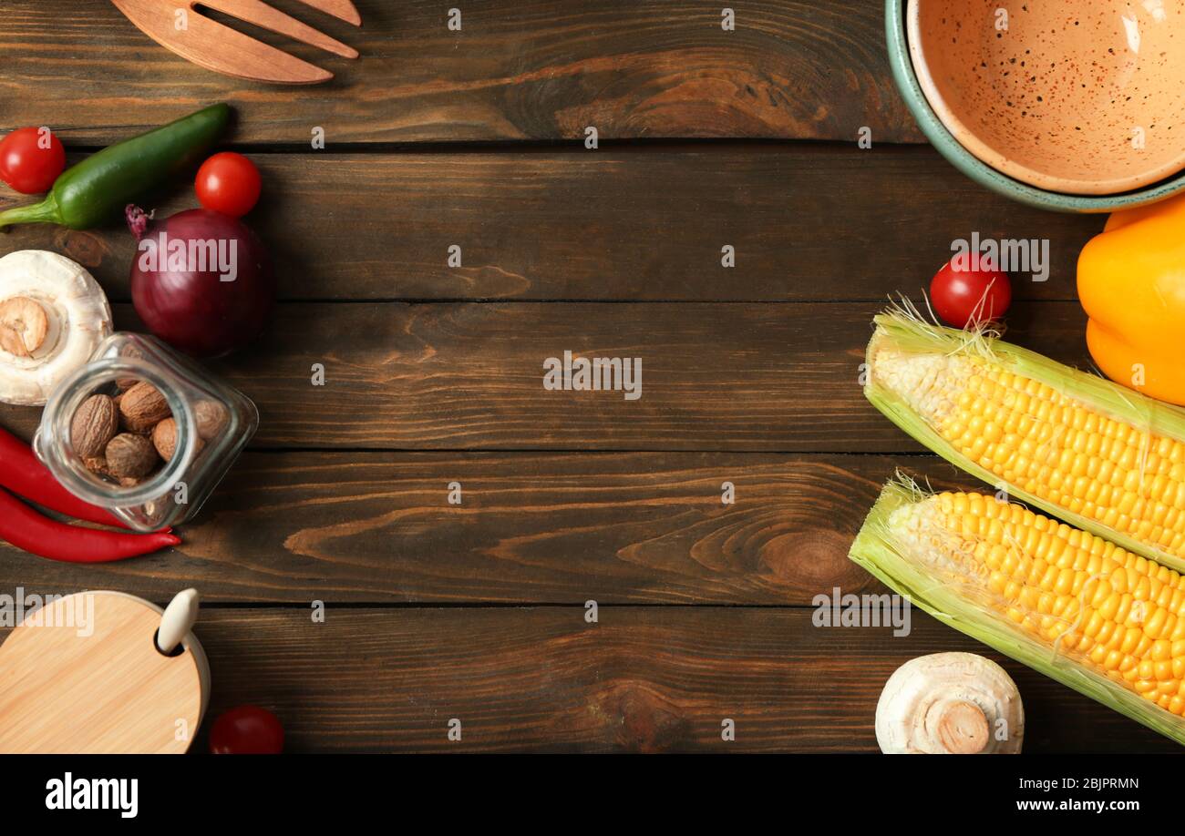 Fresh vegetables and kitchen utensils on wooden background Stock Photo ...