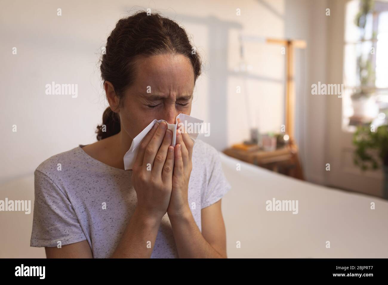Sick Caucasian woman self isolating and social distancing in quarantine ...
