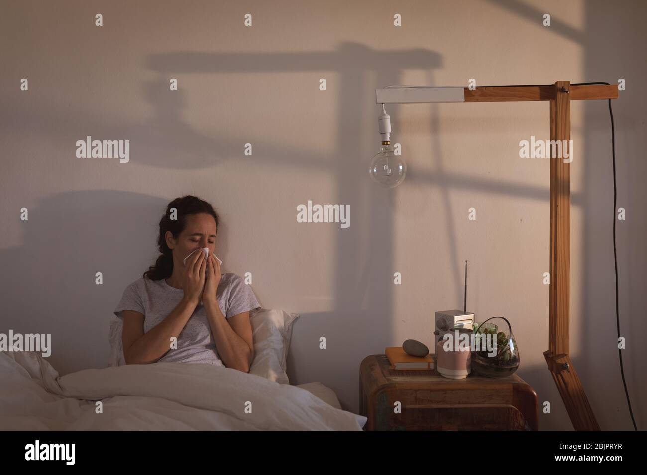 Sick Caucasian woman self isolating and social distancing in quarantine ...