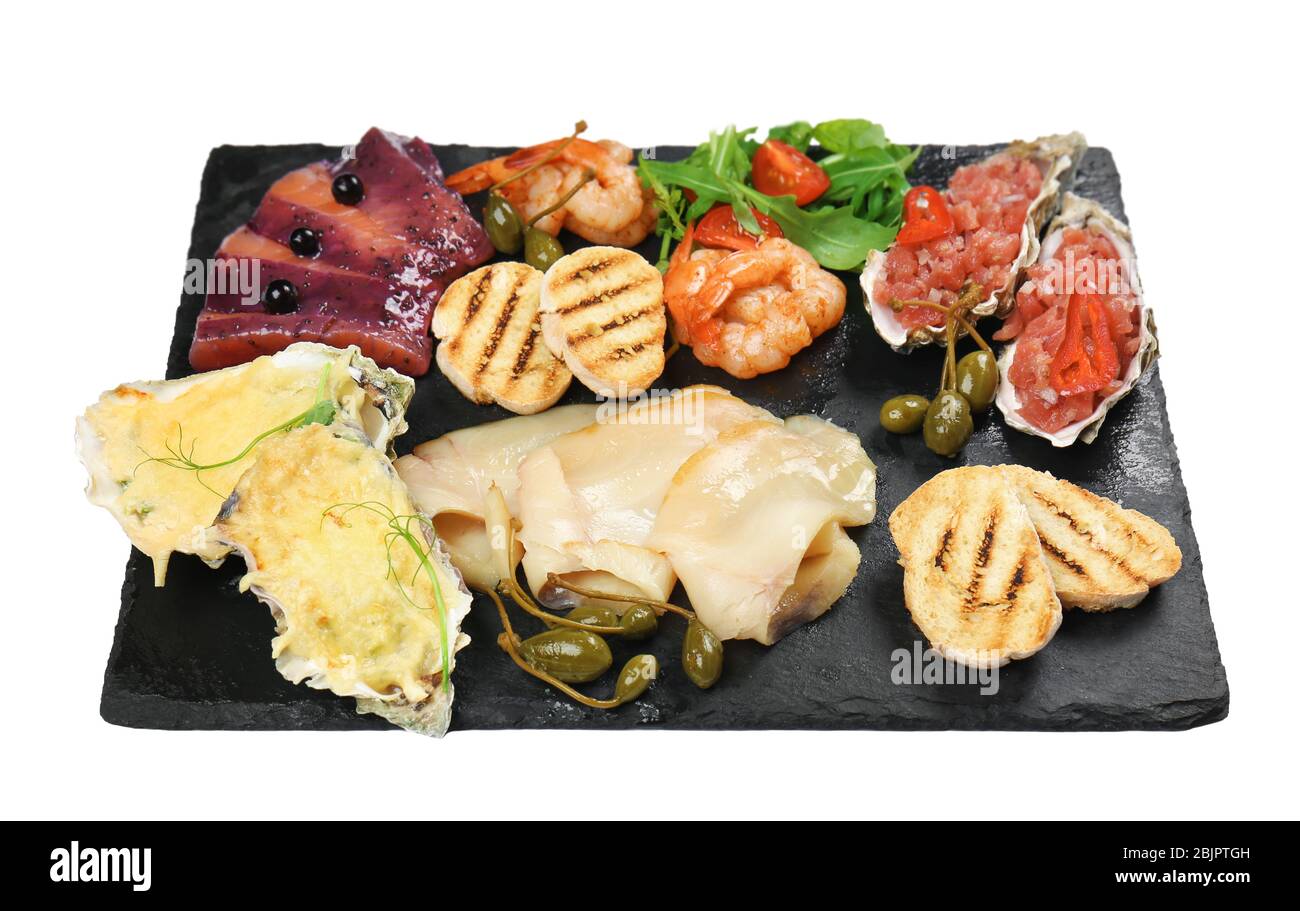 Slate plate with various seafood snacks on white background Stock Photo ...