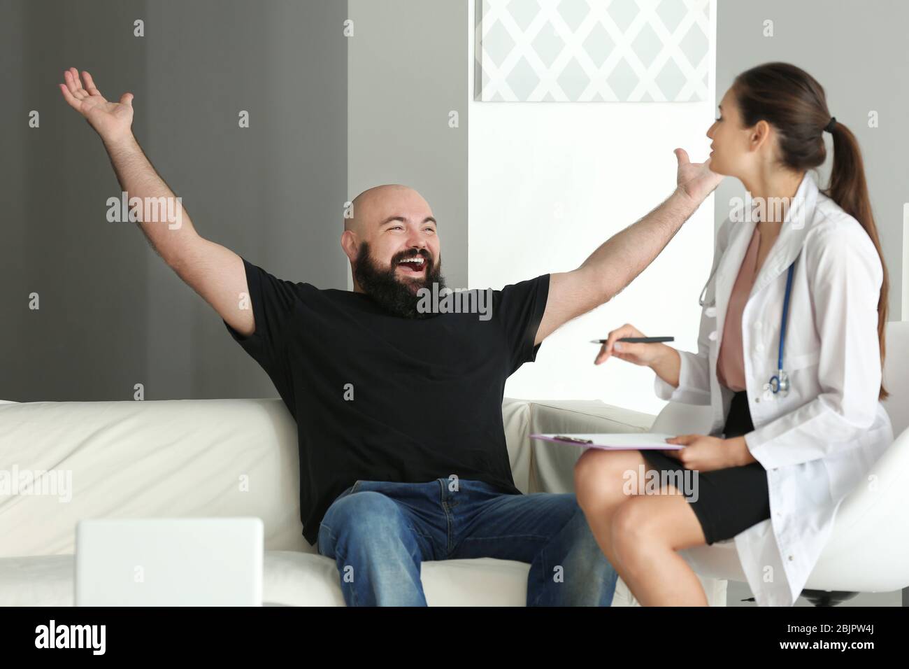 Young female doctor consulting overweight man in clinic Stock Photo - Alamy