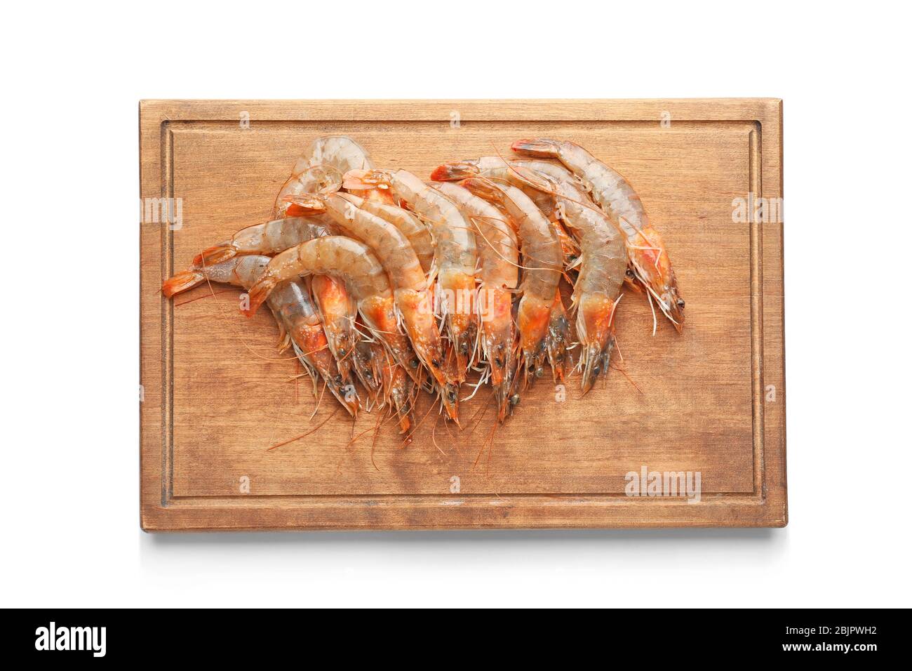 Raw shrimps on wooden Cut Out Stock Images & Pictures - Alamy