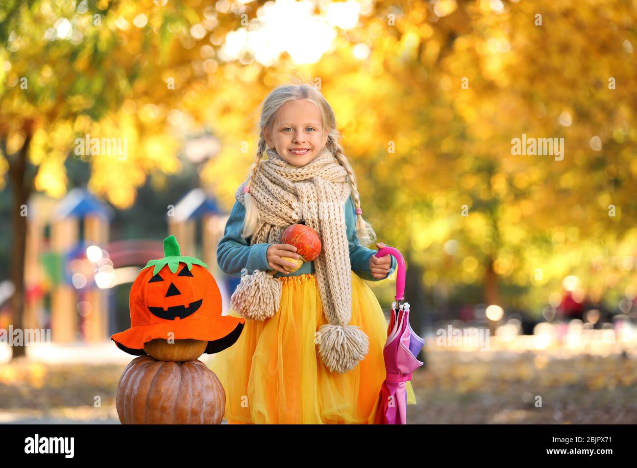 Cute little girl wearing Halloween costume in autumn park Stock Photo ...