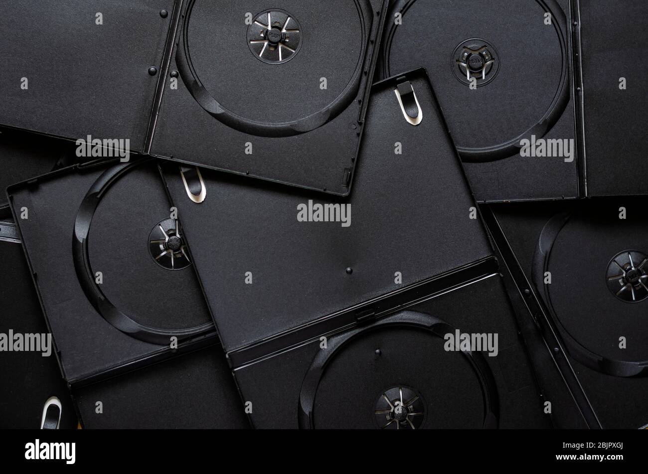 Empty black box dvd background. A pile of open plastic boxes for cd ...