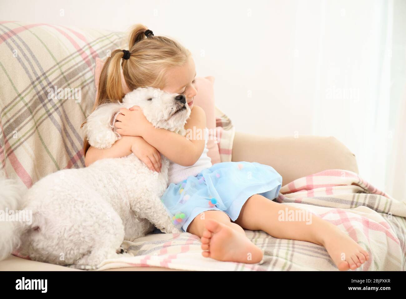 Adorable little girl with her dog at home Stock Photo - Alamy