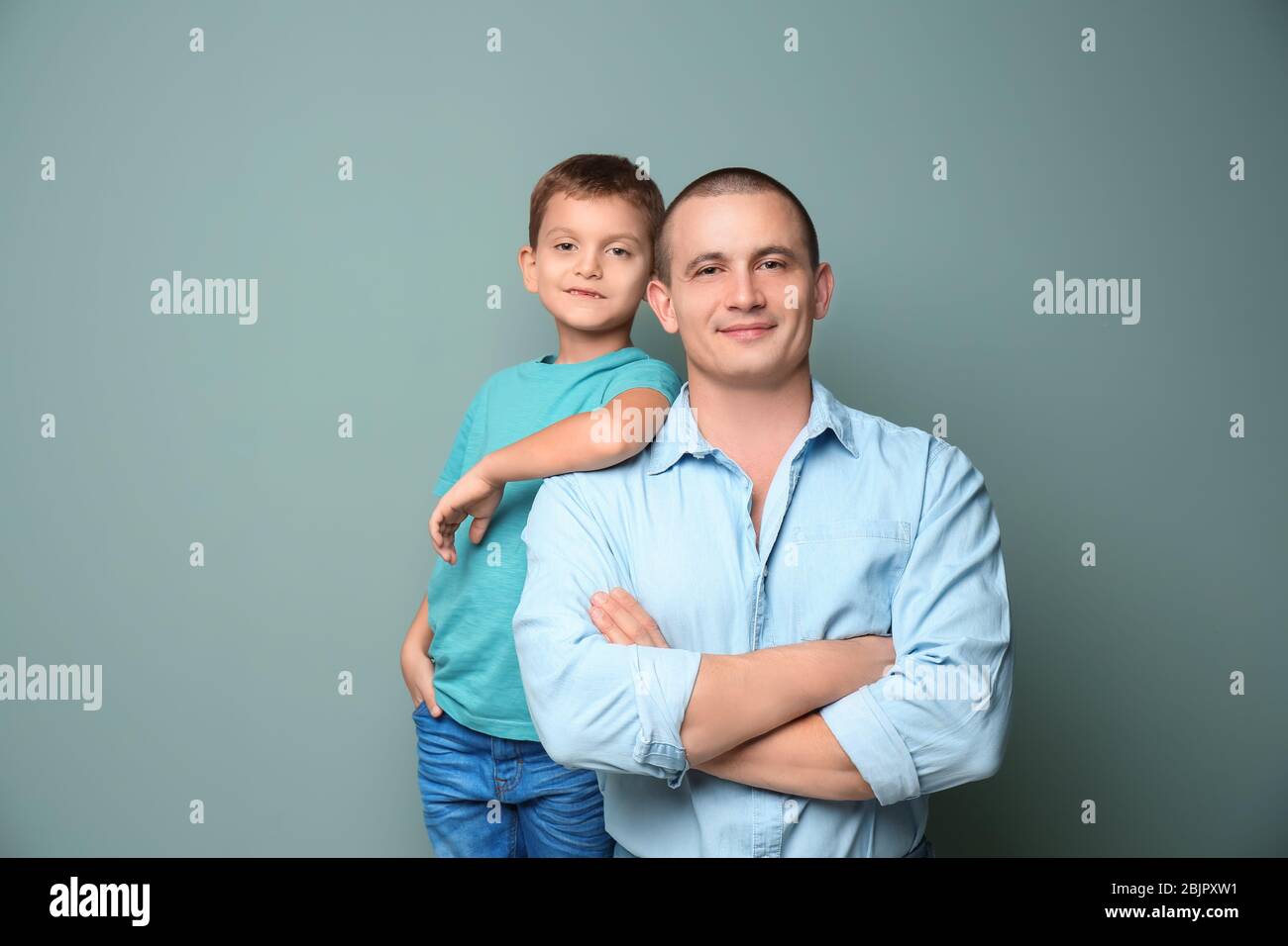 Dad and his son on color background Stock Photo - Alamy