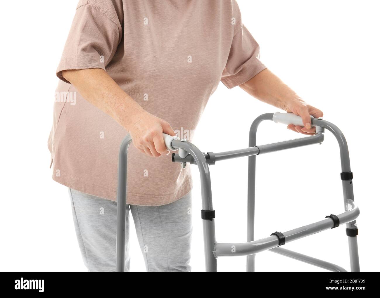 Elderly woman with walking frame on white background Stock Photo - Alamy