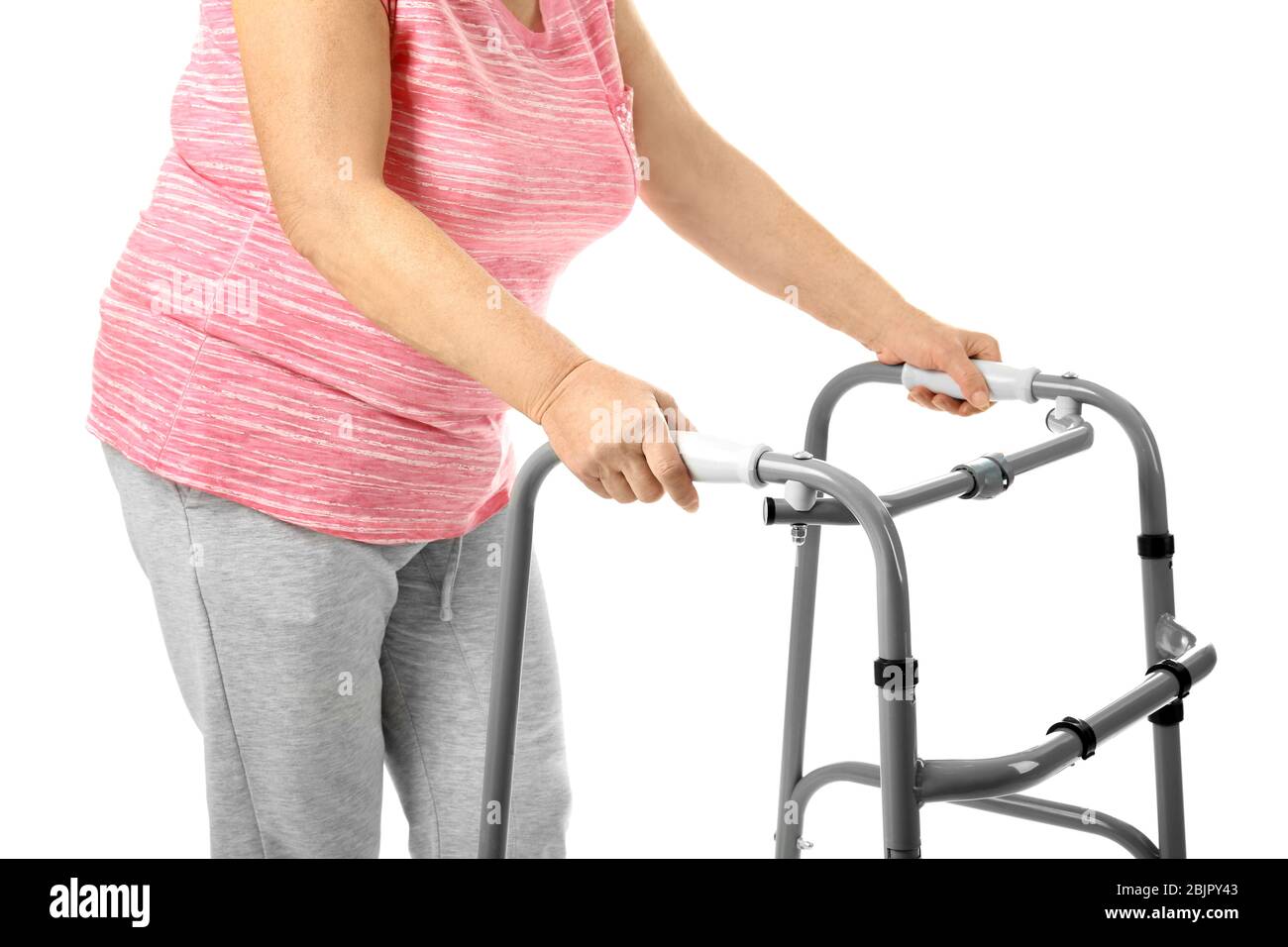 Elderly woman with walking frame on white background Stock Photo - Alamy