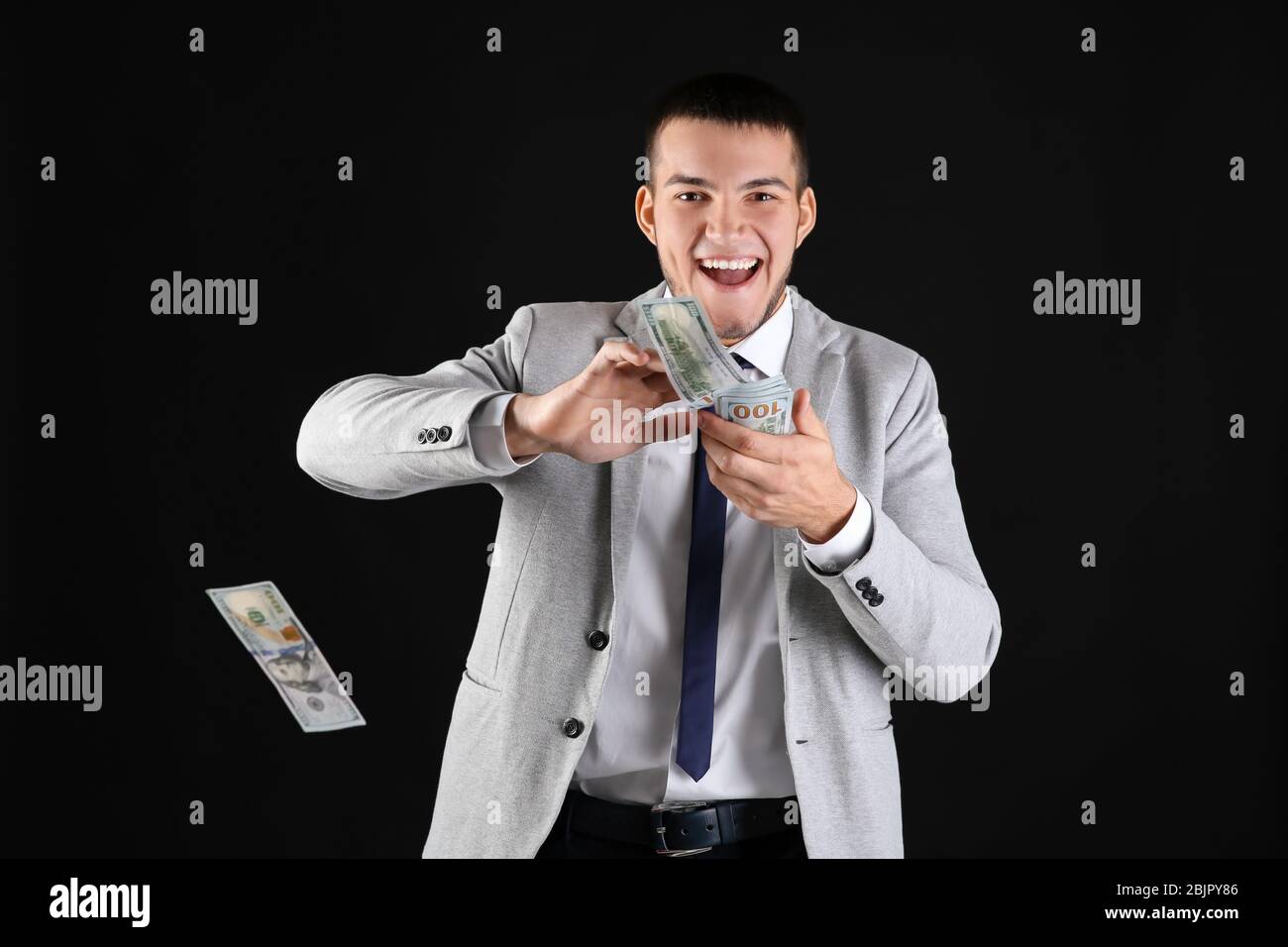 Happy rich man throwing money hi-res stock photography and images - Alamy