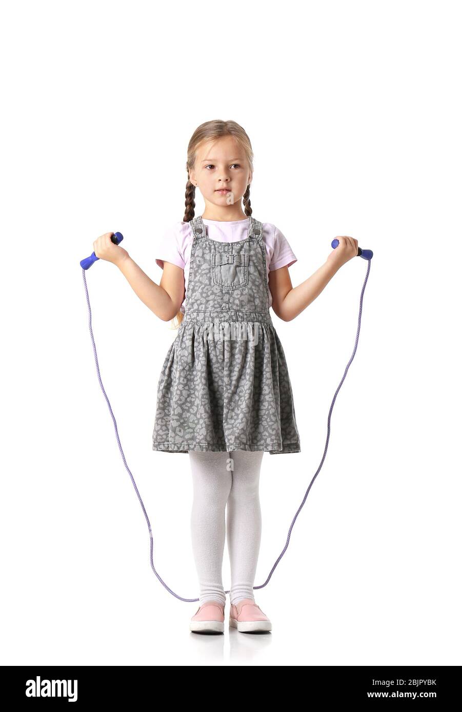 Cute little girl playing with jumping rope on white background Stock ...