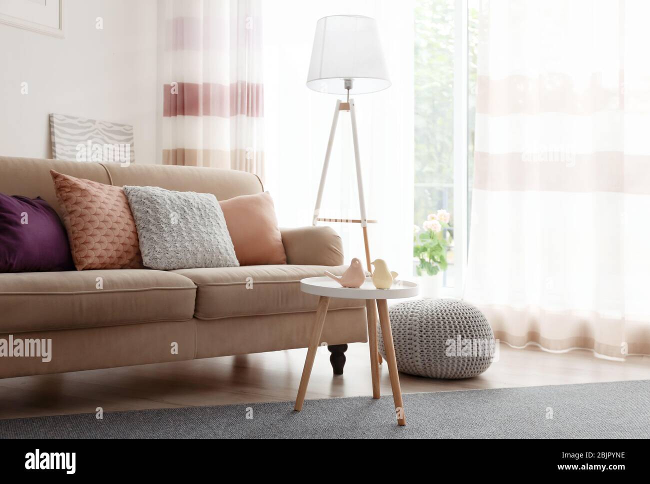 Modern living room interior with cozy sofa Stock Photo - Alamy