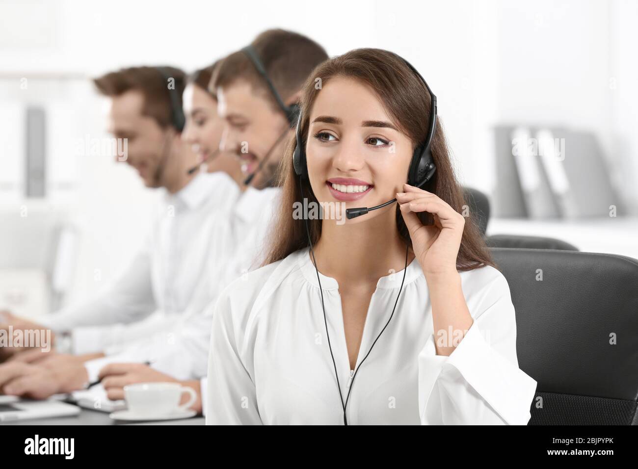 Female consulting manager with headset in office Stock Photo - Alamy
