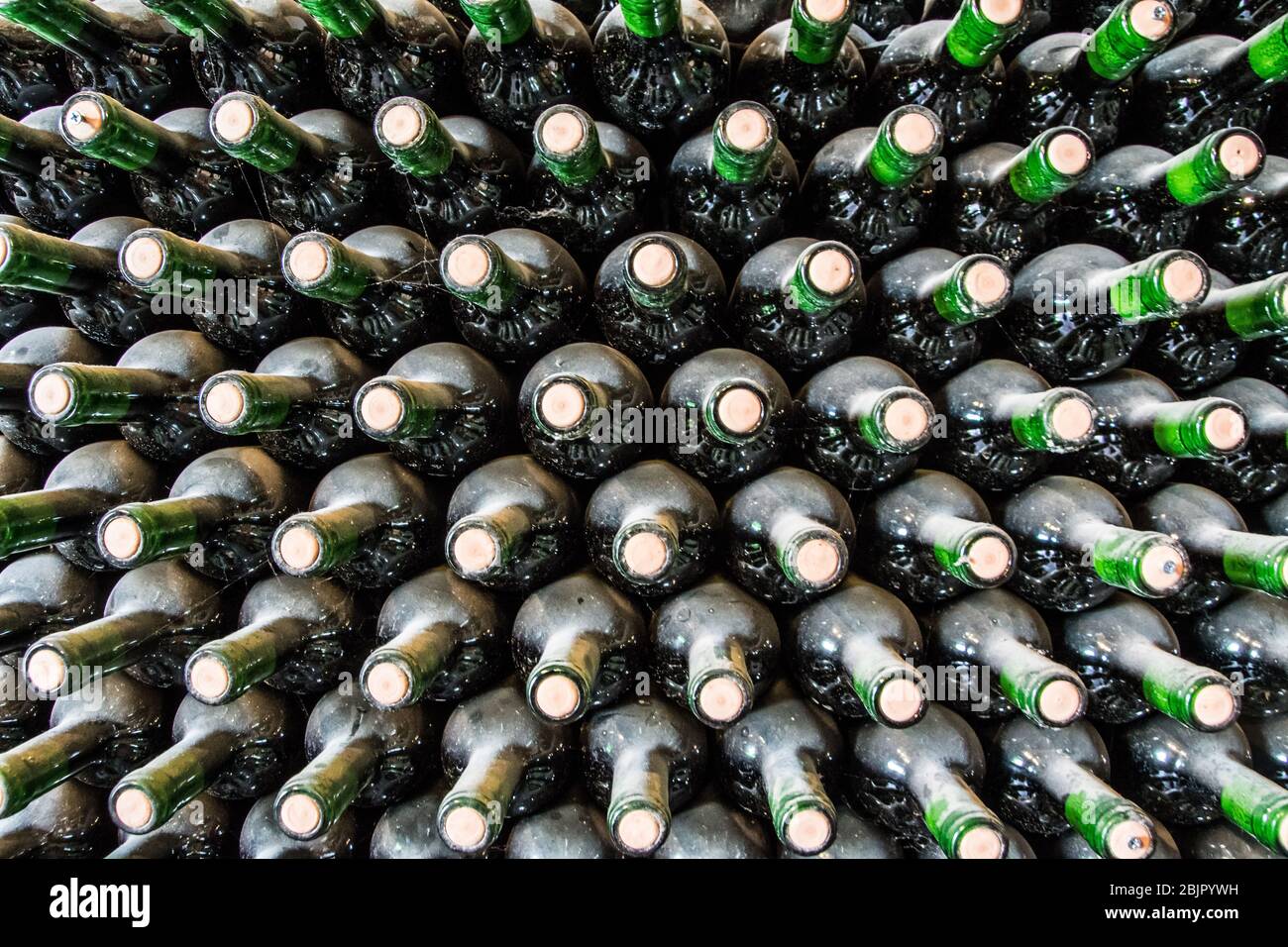 Stacked up dusty wine bottles in a wine cellar Stock Photo - Alamy