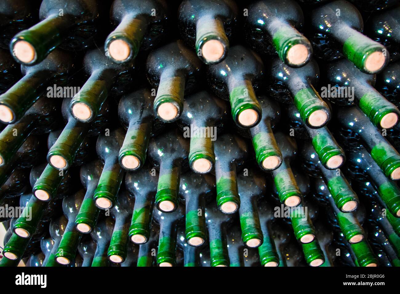 Stacked up dusty wine bottles in a wine cellar Stock Photo - Alamy