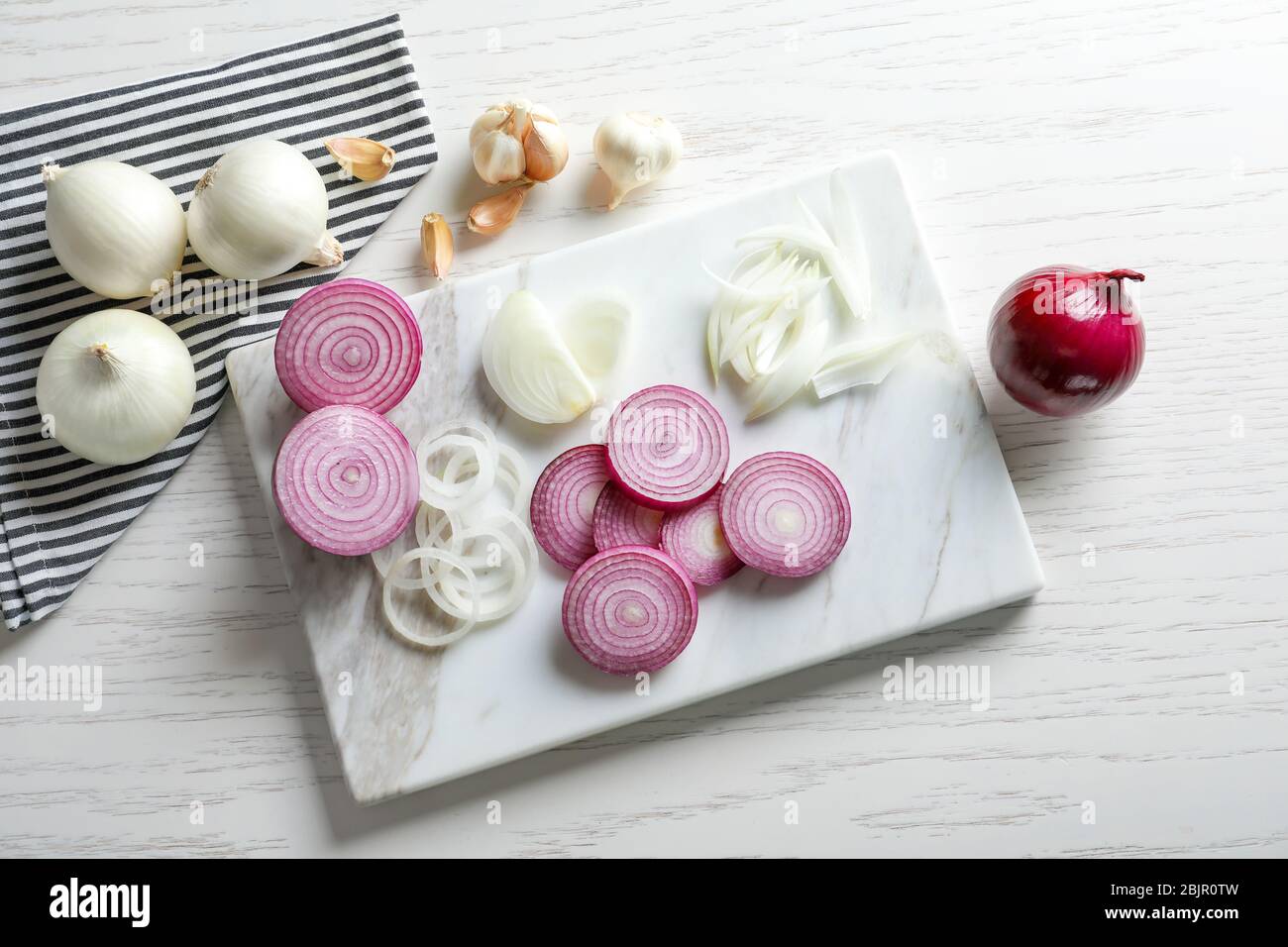 Fresh cut onion on marble board Stock Photo - Alamy