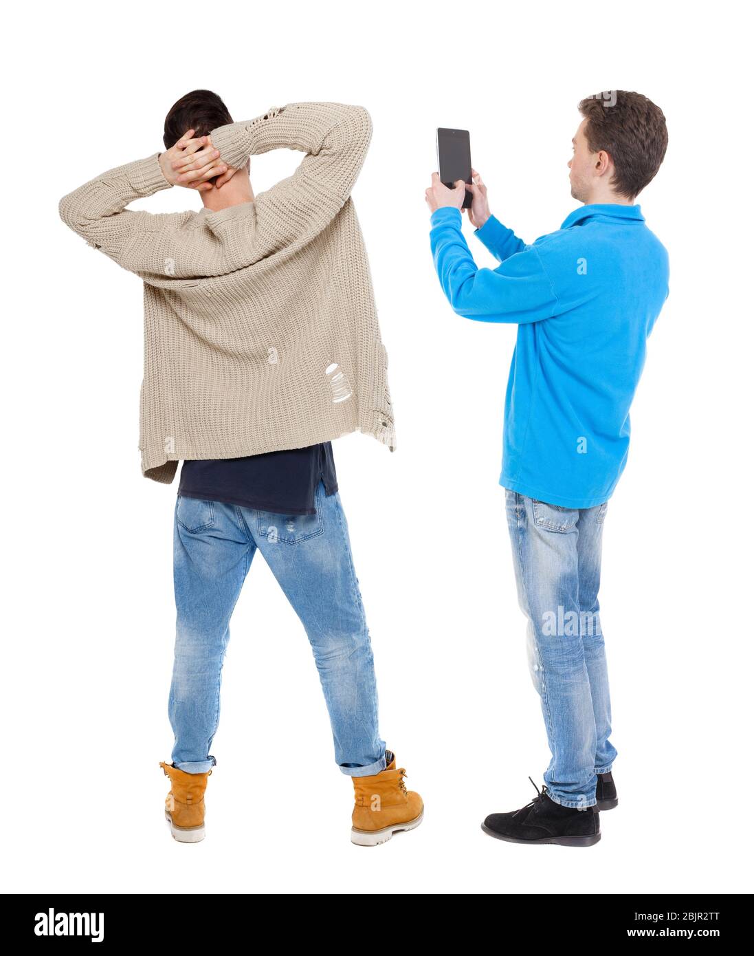 Back view of two man in sweater with mobile phone. Rear view people ...