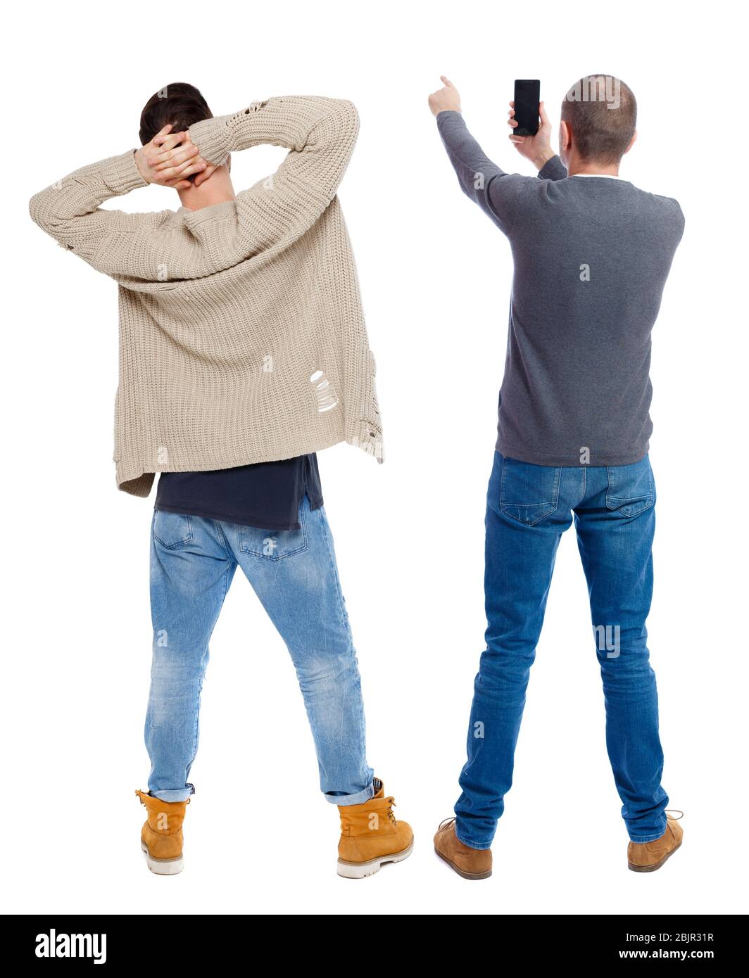 Back view of two man in sweater with mobile phone. Rear view people ...