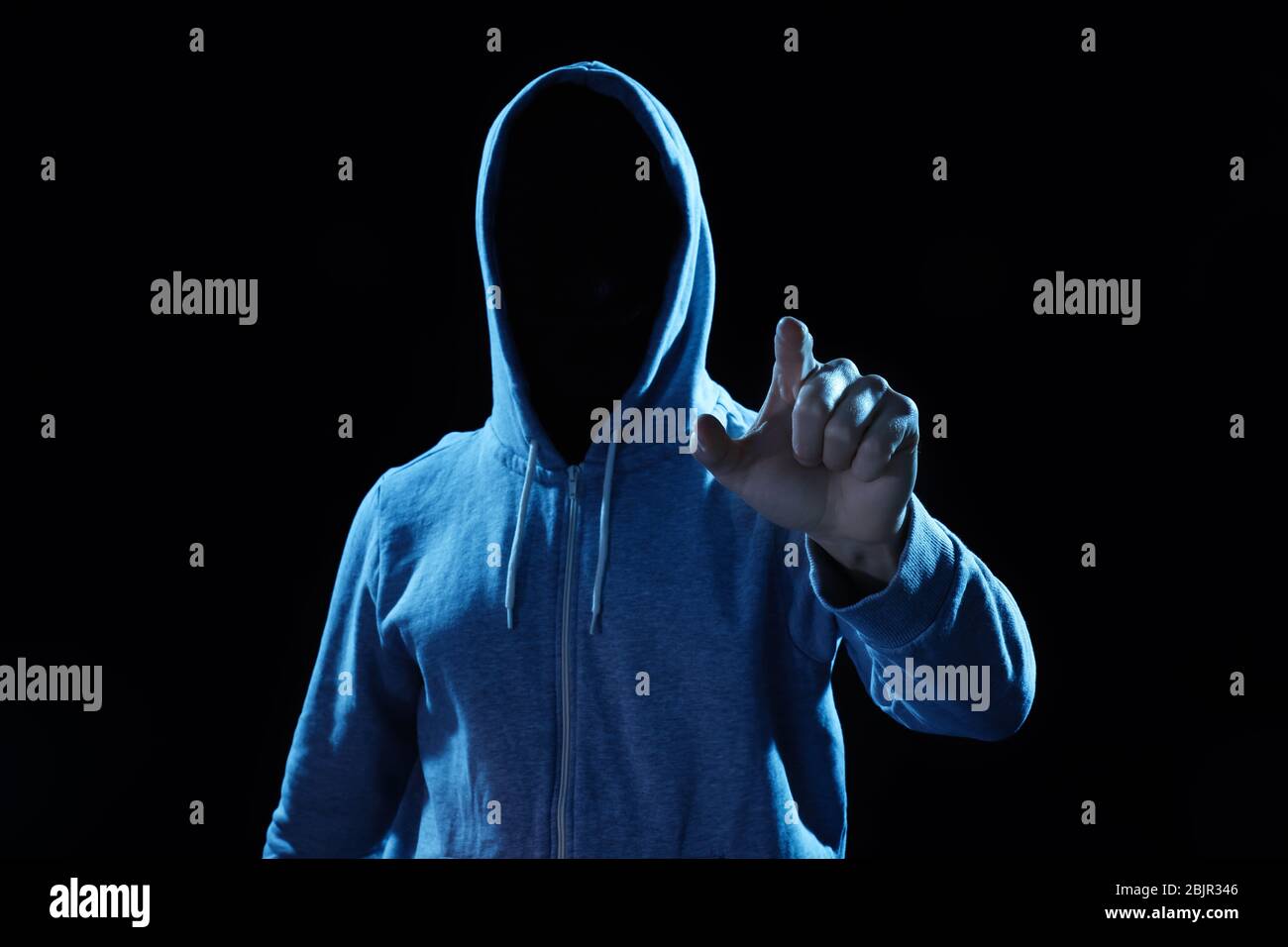 Hacker pushing button on virtual screen against dark background Stock ...