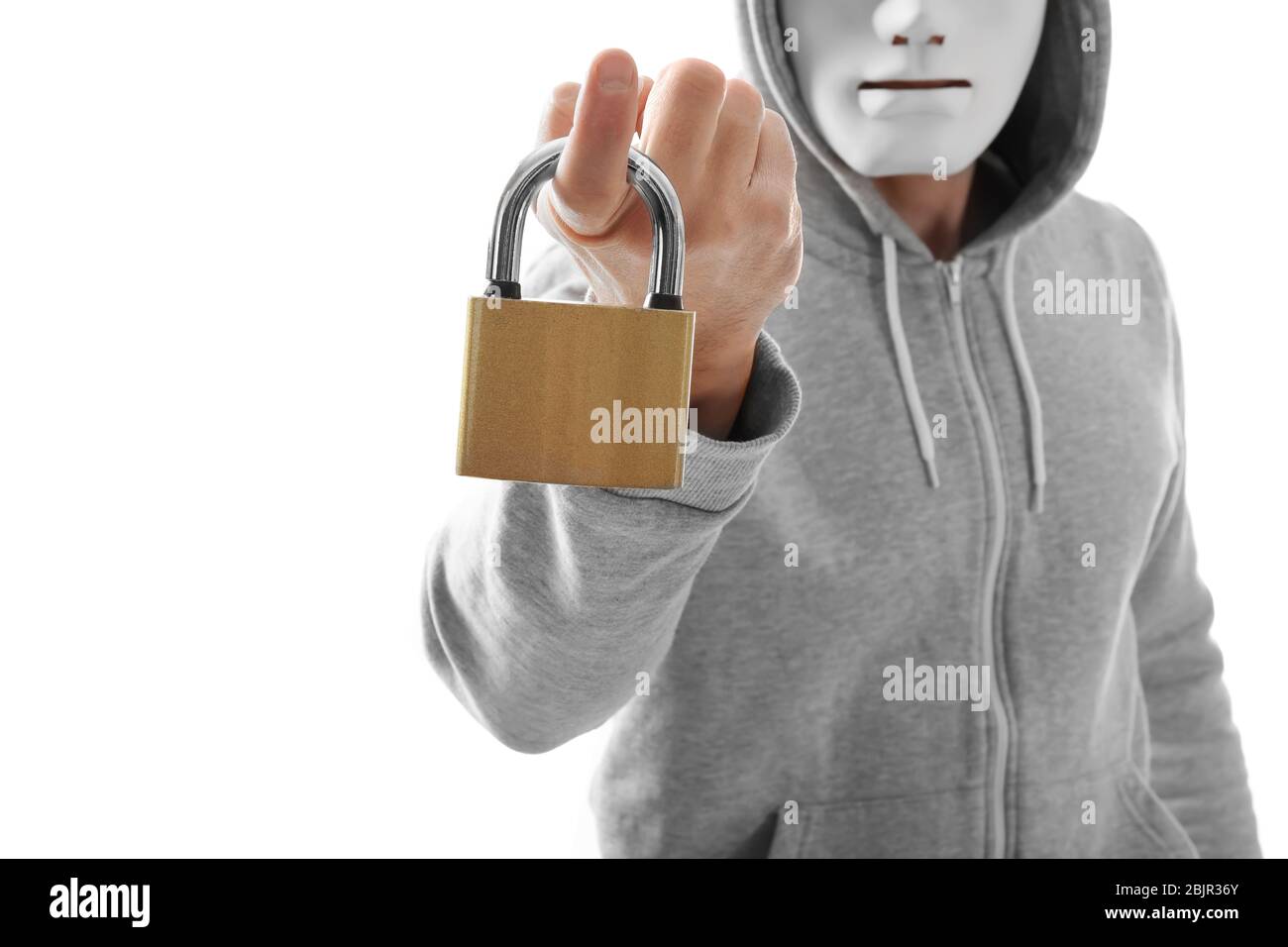 Hacker in mask holding lock on white background Stock Photo - Alamy