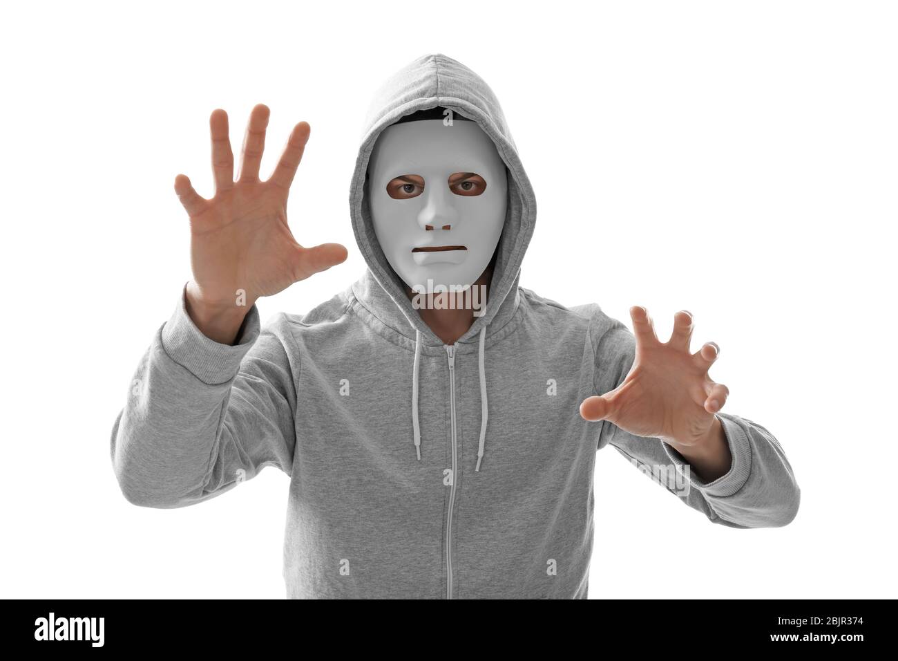 Hacker in mask working with virtual screen on white background Stock ...
