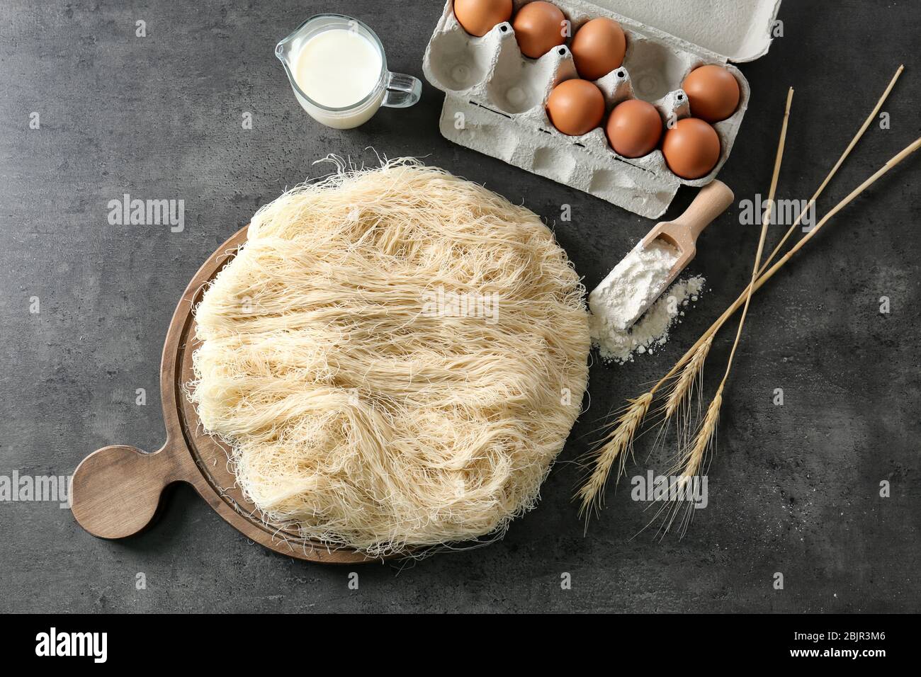 Shredded thin dough with ingredients on table Stock Photo - Alamy