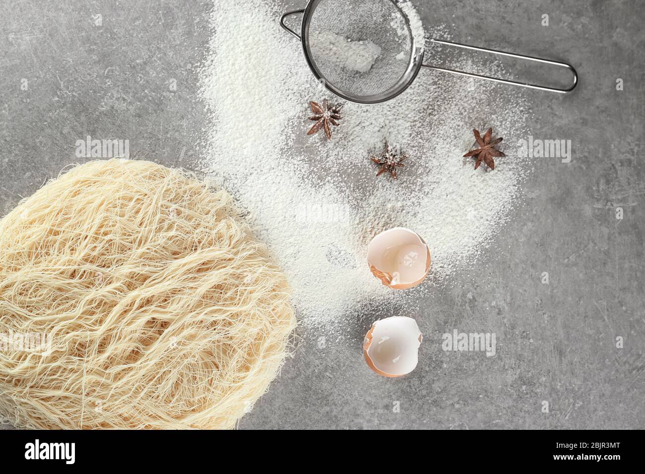 Shredded thin dough with sieve on table Stock Photo - Alamy