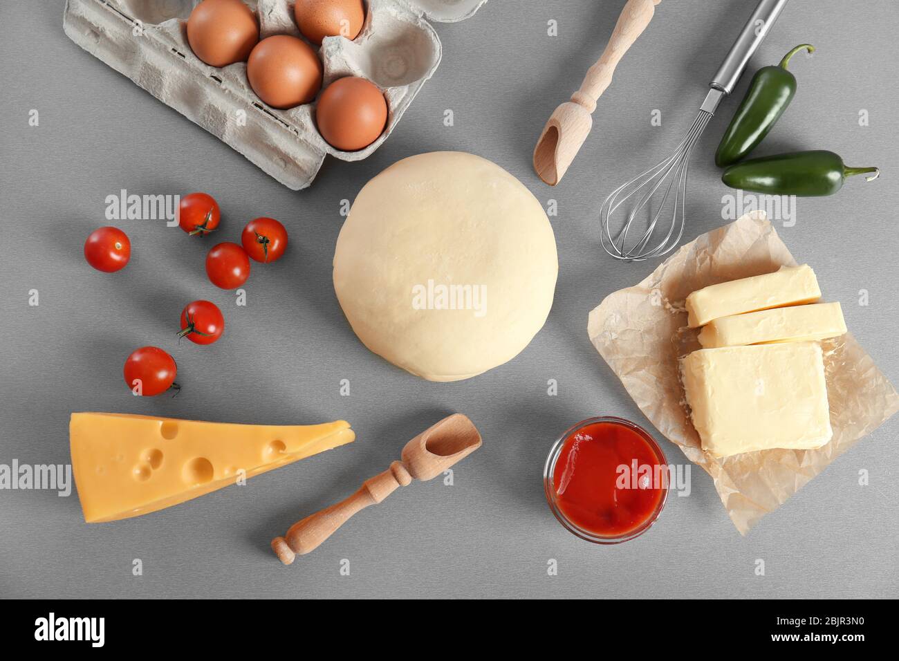 Raw dough and ingredients for pizza on table Stock Photo - Alamy