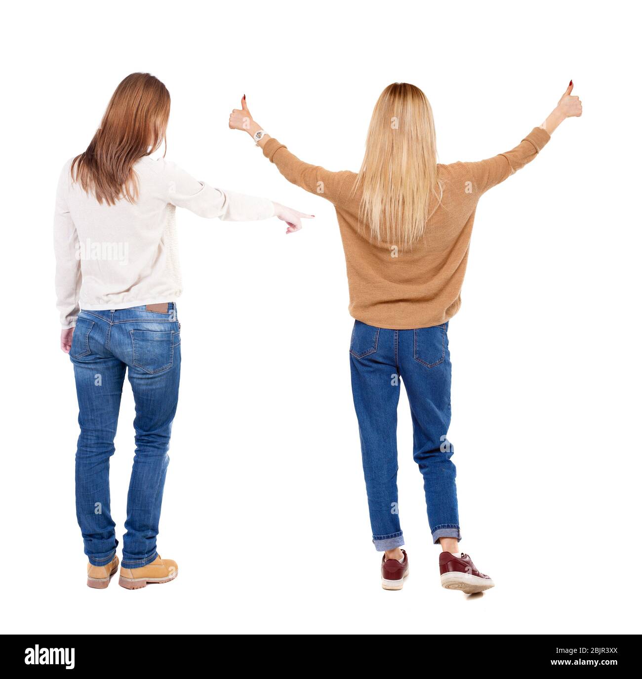 Back view of two pointing girl in sweater. Rear view people collection ...