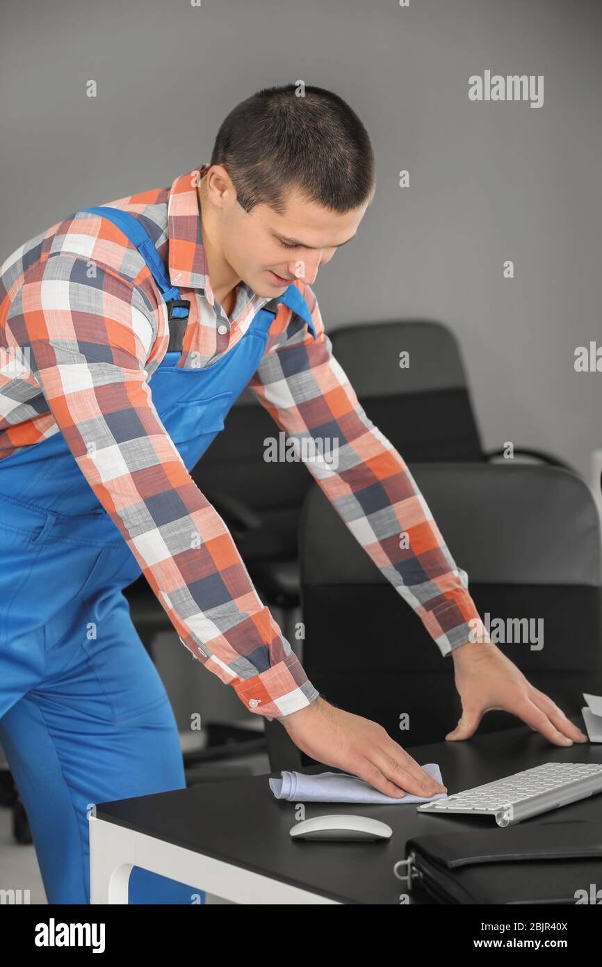 Man cleaning table in office hi-res stock photography and images - Alamy