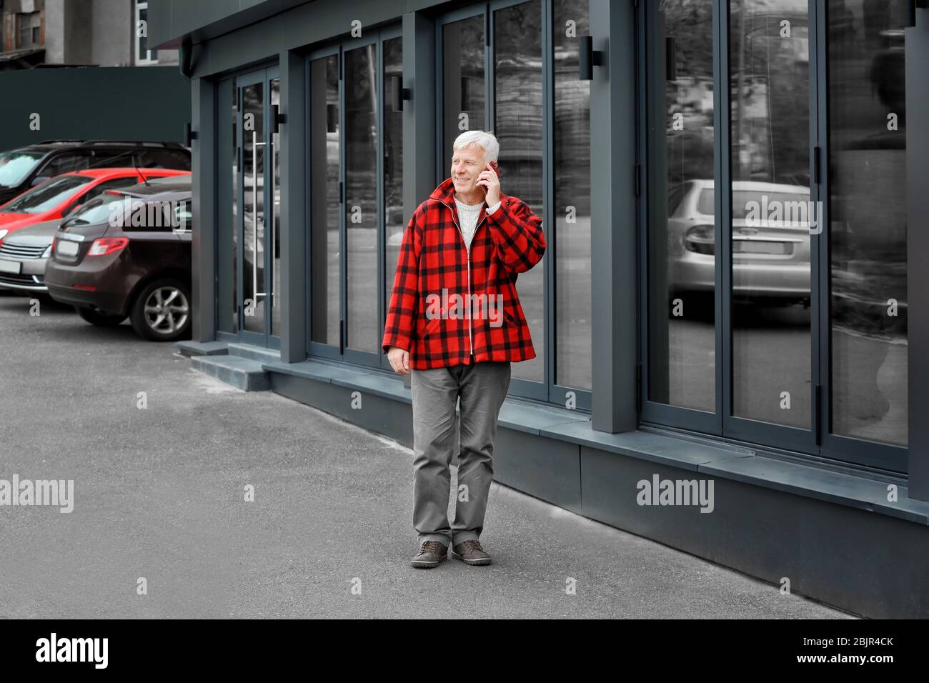 Handsome mature man talking on phone outdoors Stock Photo - Alamy