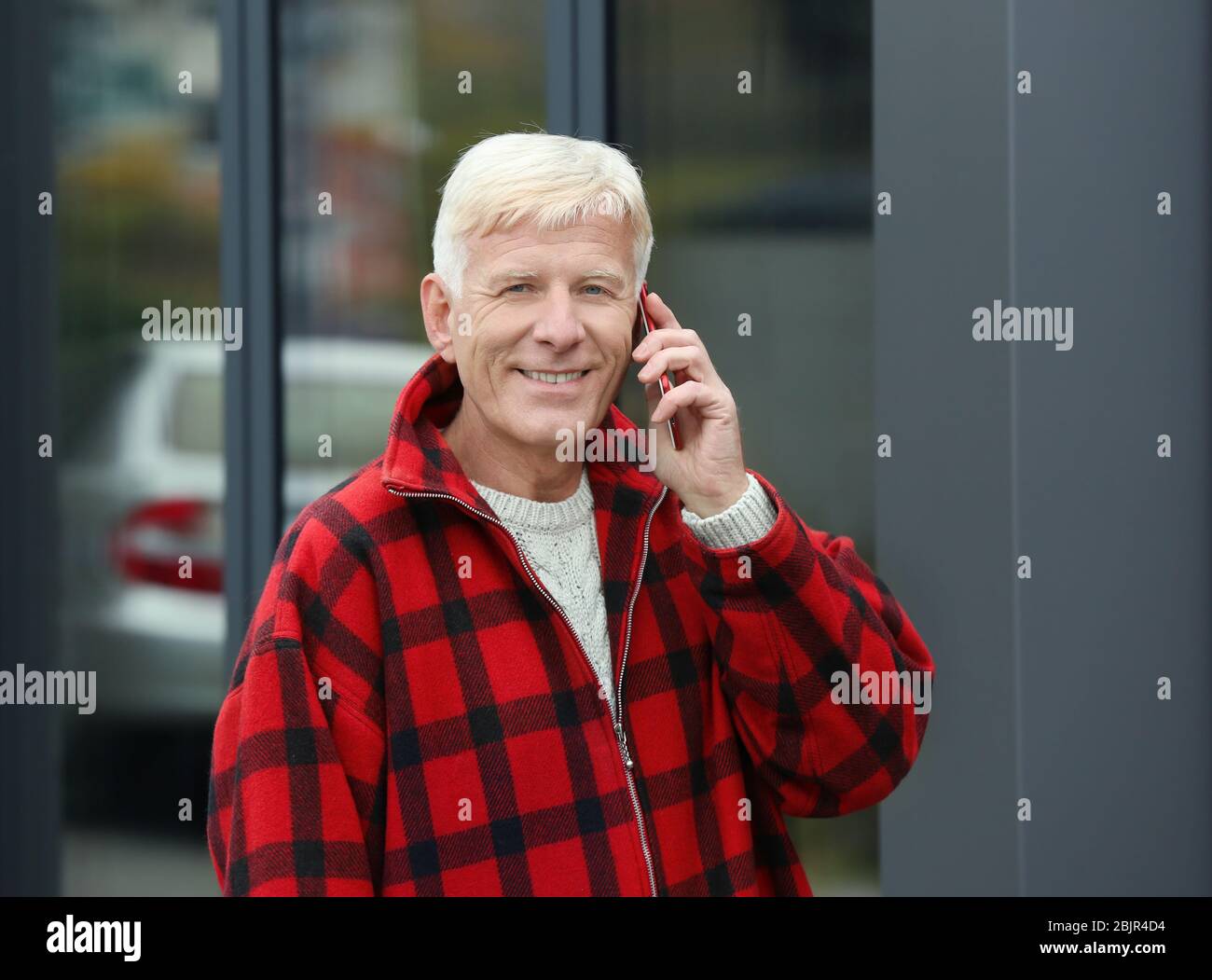 Handsome mature man talking on phone outdoors Stock Photo - Alamy
