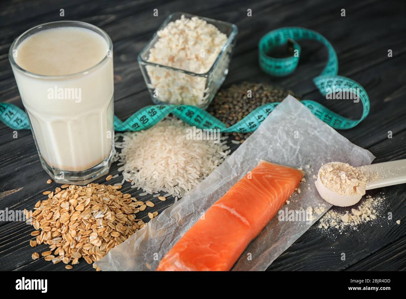 High protein food and powder on wooden table Stock Photo - Alamy